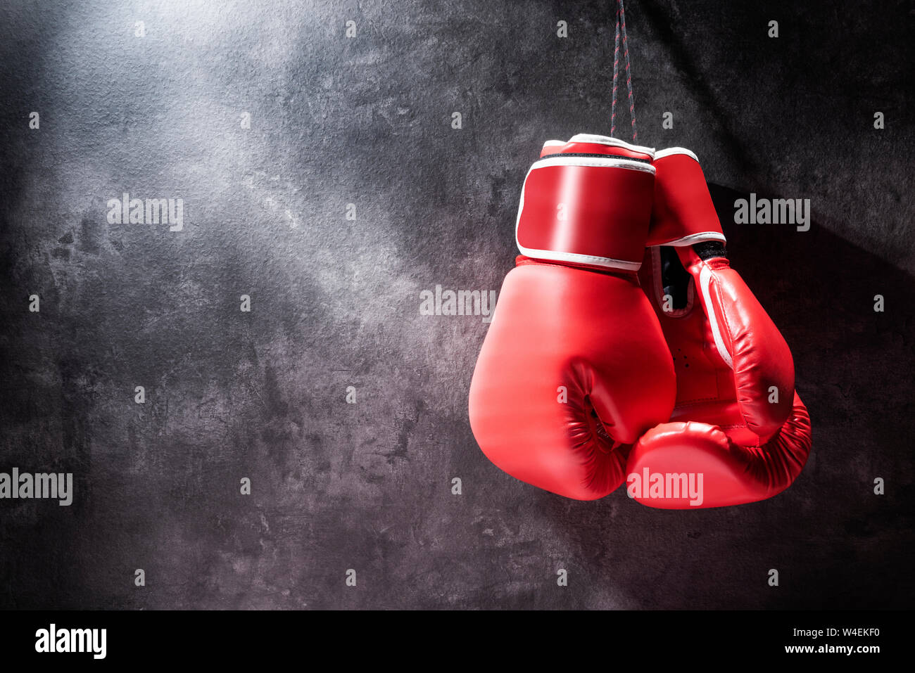 Pair of red boxing gloves hanging on the wall Stock Photo - Alamy