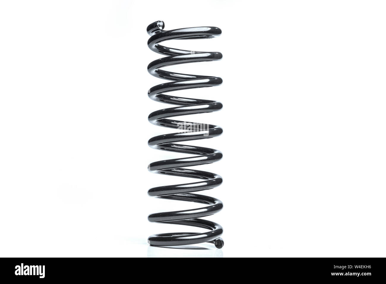 Black coil spring isolated over white background Stock Photo - Alamy