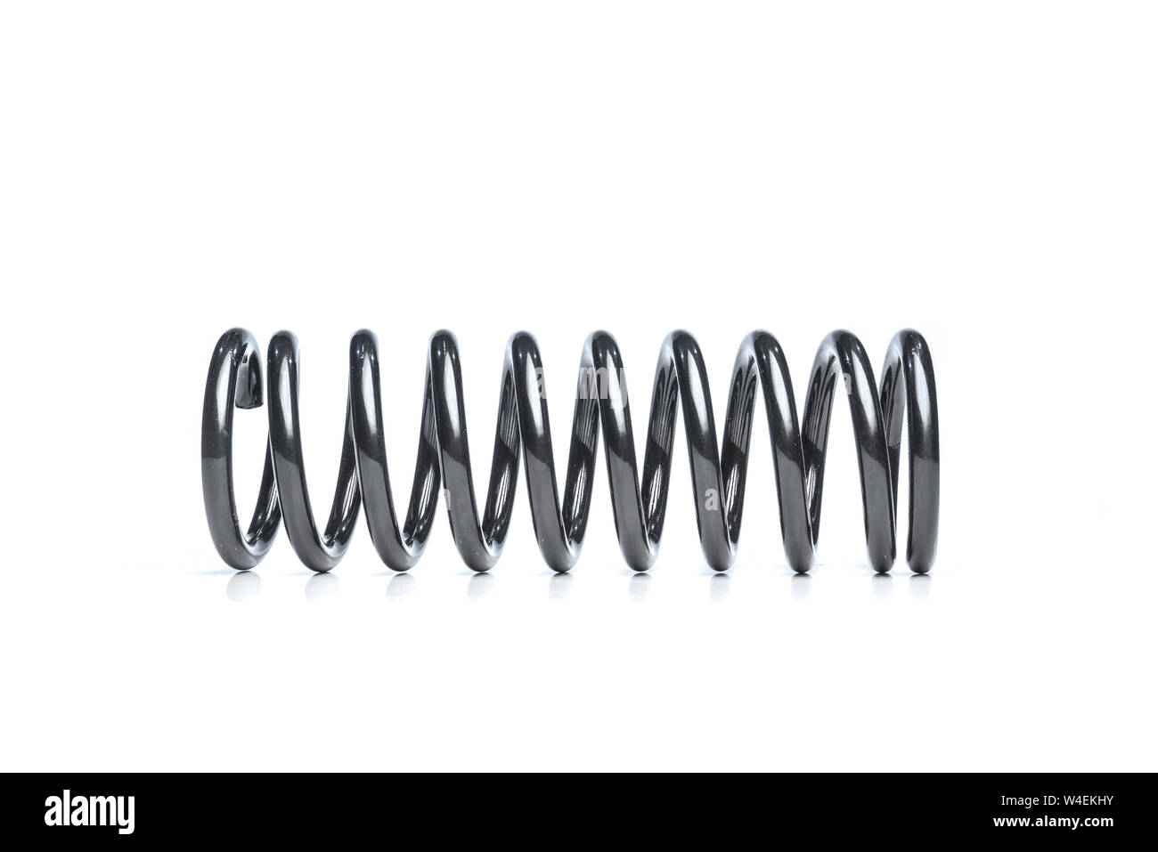 Black coil spring isolated over white background Stock Photo - Alamy