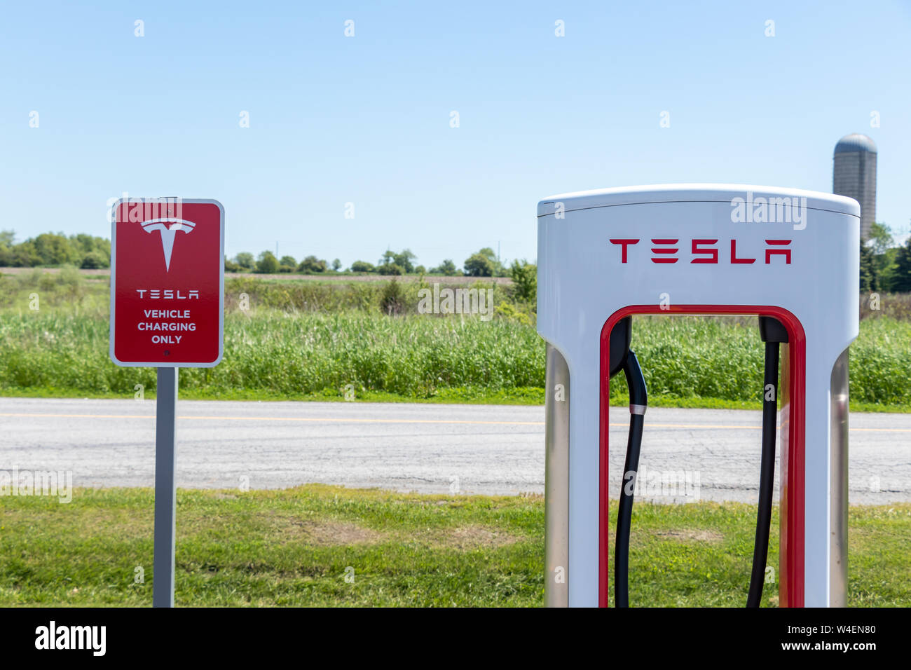 Tesla Supercharger and Tesla "Electric Vehicle Only" warning sign with ...