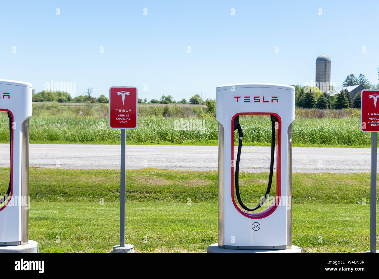 Tesla Supercharger and Tesla "Electric Vehicle Only" warning sign with ...