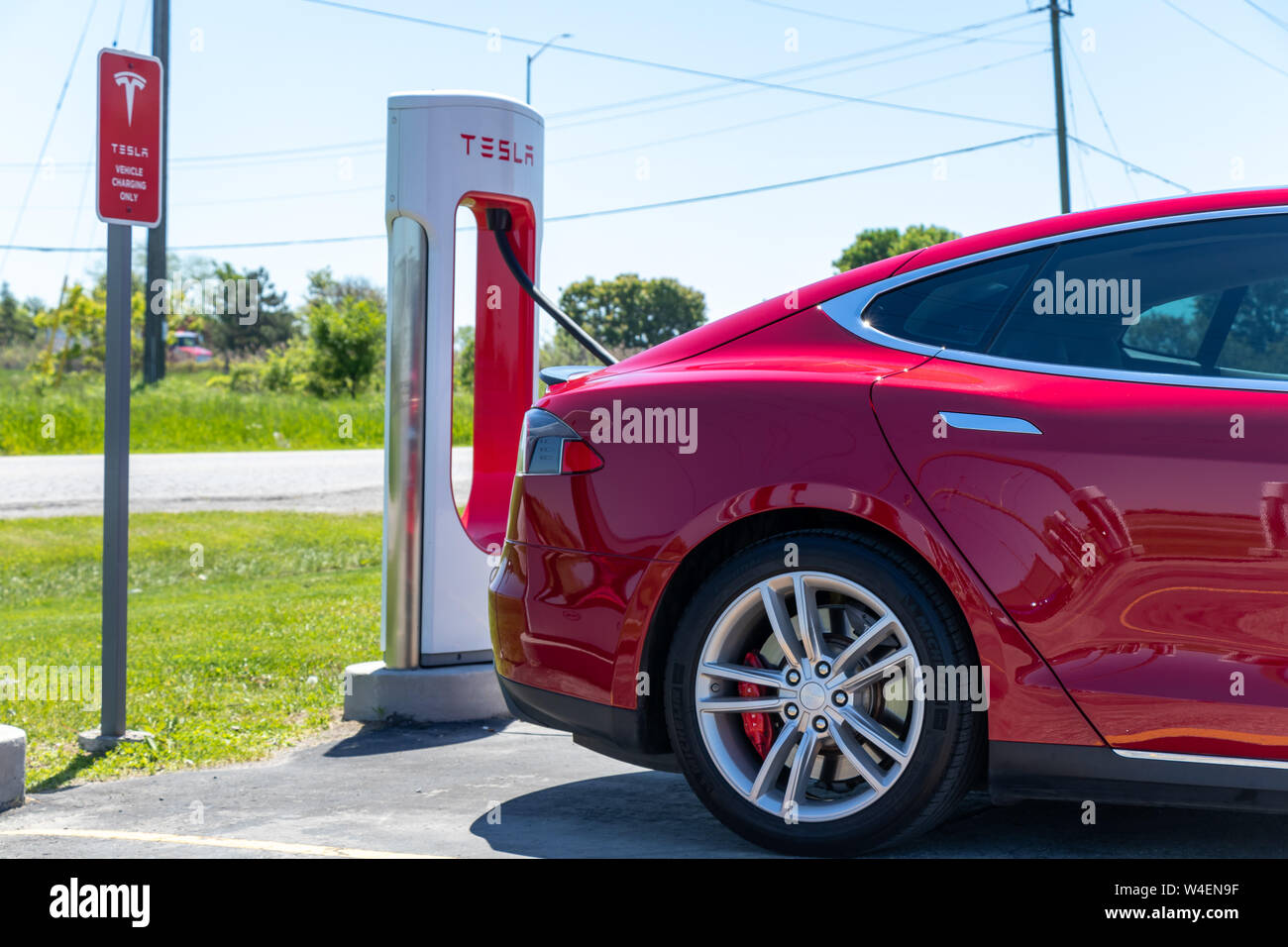 Shining Tesla Model S seen while charging at Tesla Supercharger Station ...