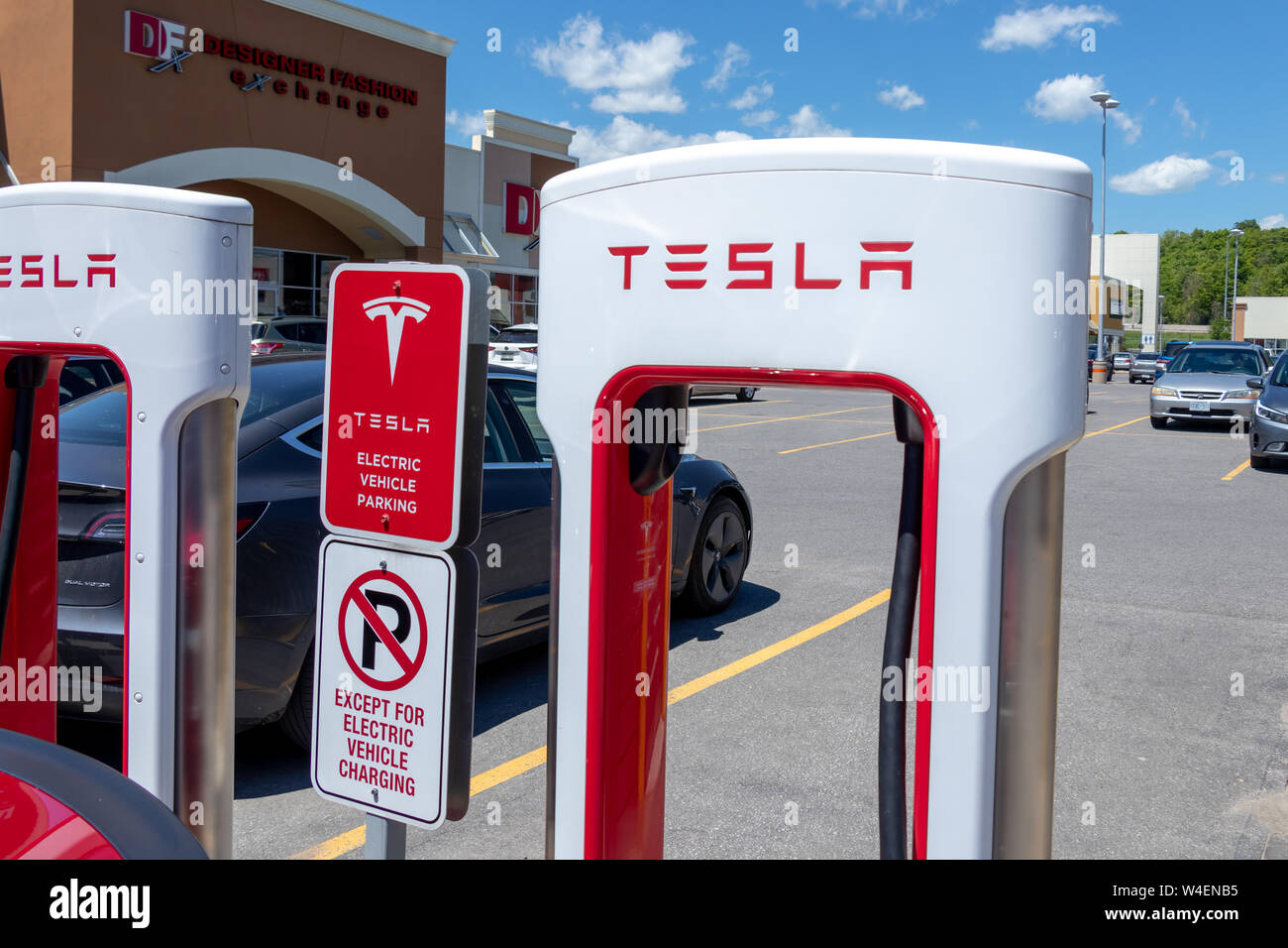 Tesla Superchargers with grey Tesla Model S parked, charging in the ...