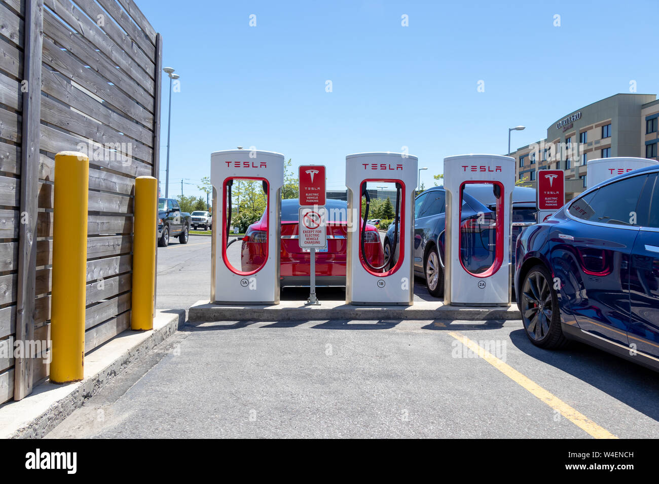 Three Tesla Supercharging Stations with Blue Model S charging in-front ...
