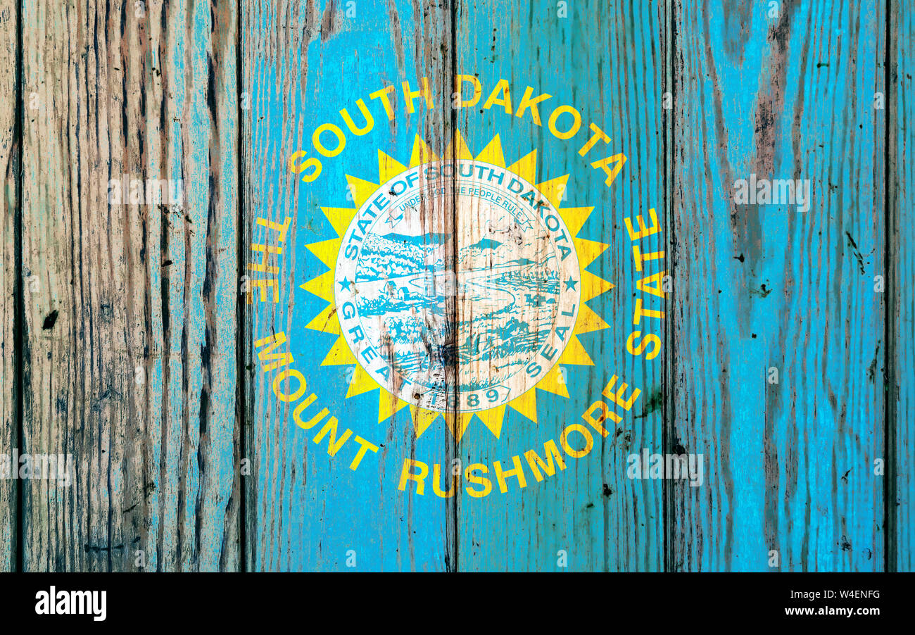 South Dakota US state national flag on a gray wooden boards background ...