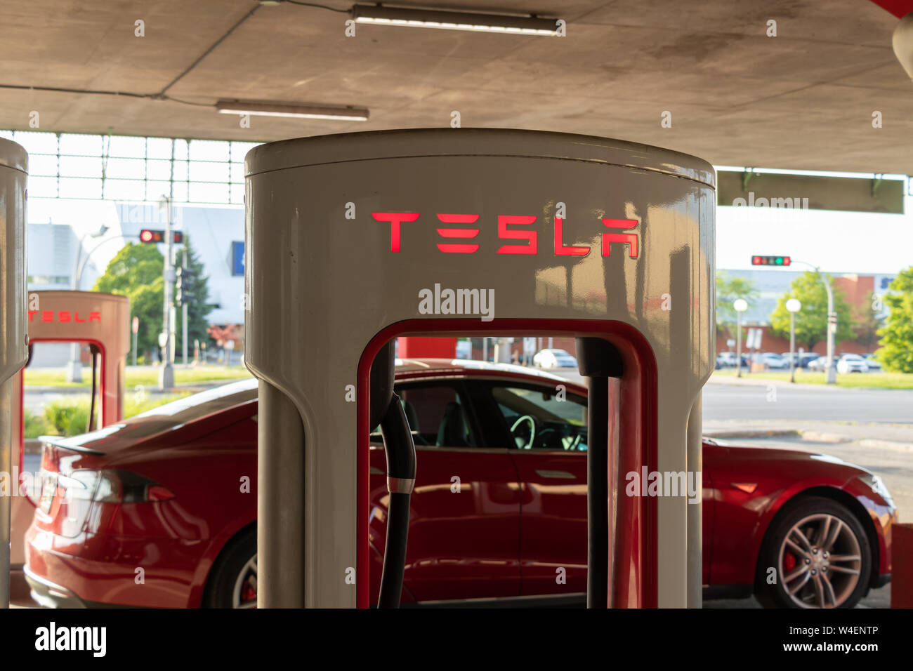 Top of Tesla Supercharger stall with Red Tesla Model S charging in the ...