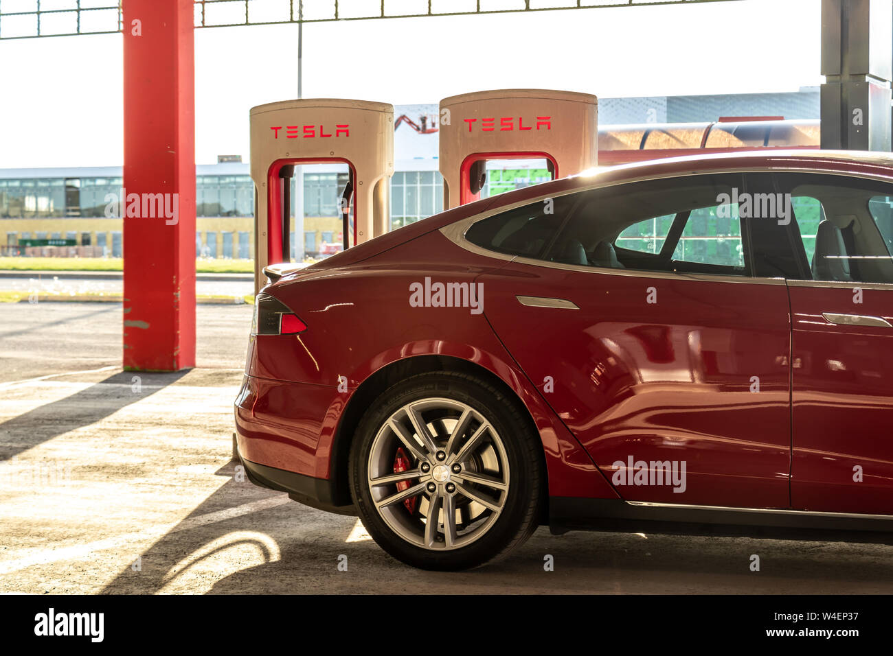 Red Tesla Model S charging at Montreal Tesla Supercharger location at ...