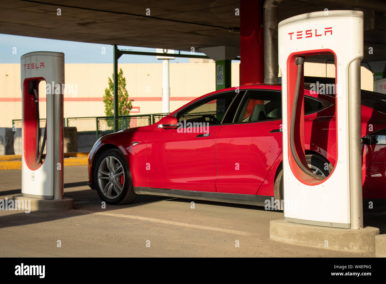 Red Tesla Model S parked at Montreal Tesla Supercharger location at ...