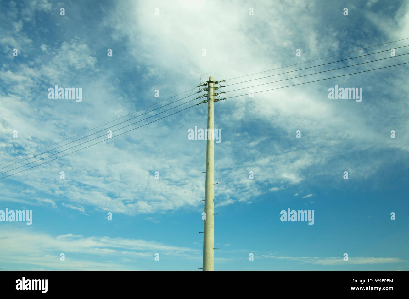 utility pole with cable under blue sky Stock Photo - Alamy