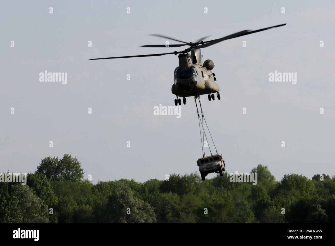 An Ohio Army National Guard CH-47 Chinook helicopter airlifts a Humvee as part of sling load ...