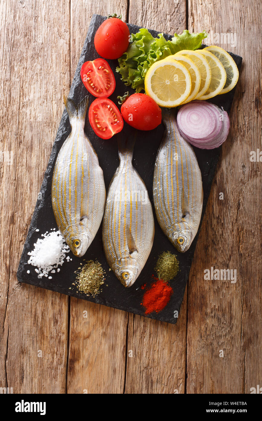 Preparation for cooking Sarpa salpa fish with lemon, vegetables and ...