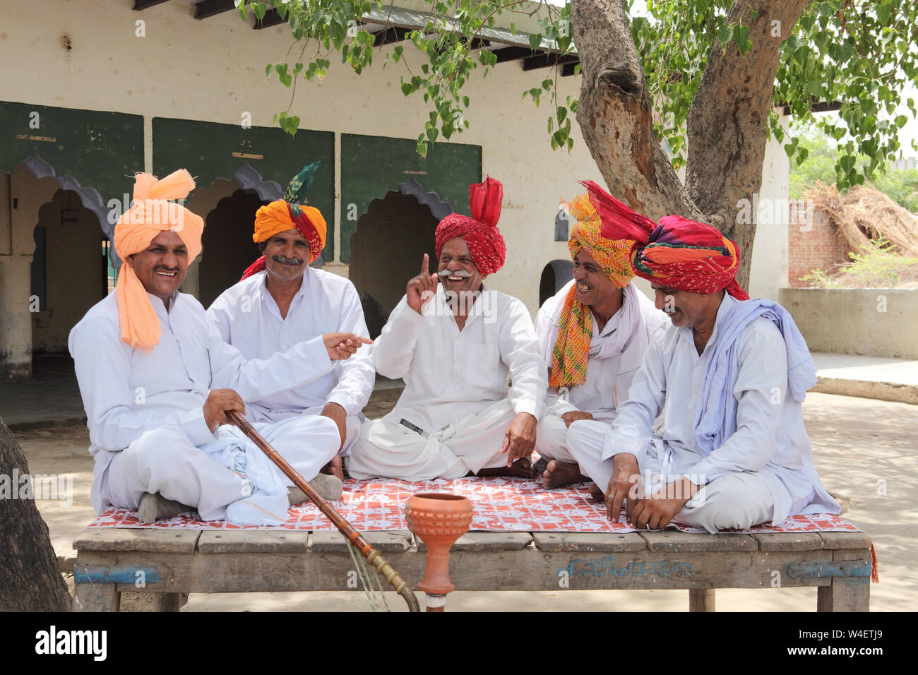 Group of rural people sitting together Stock Photo - Alamy