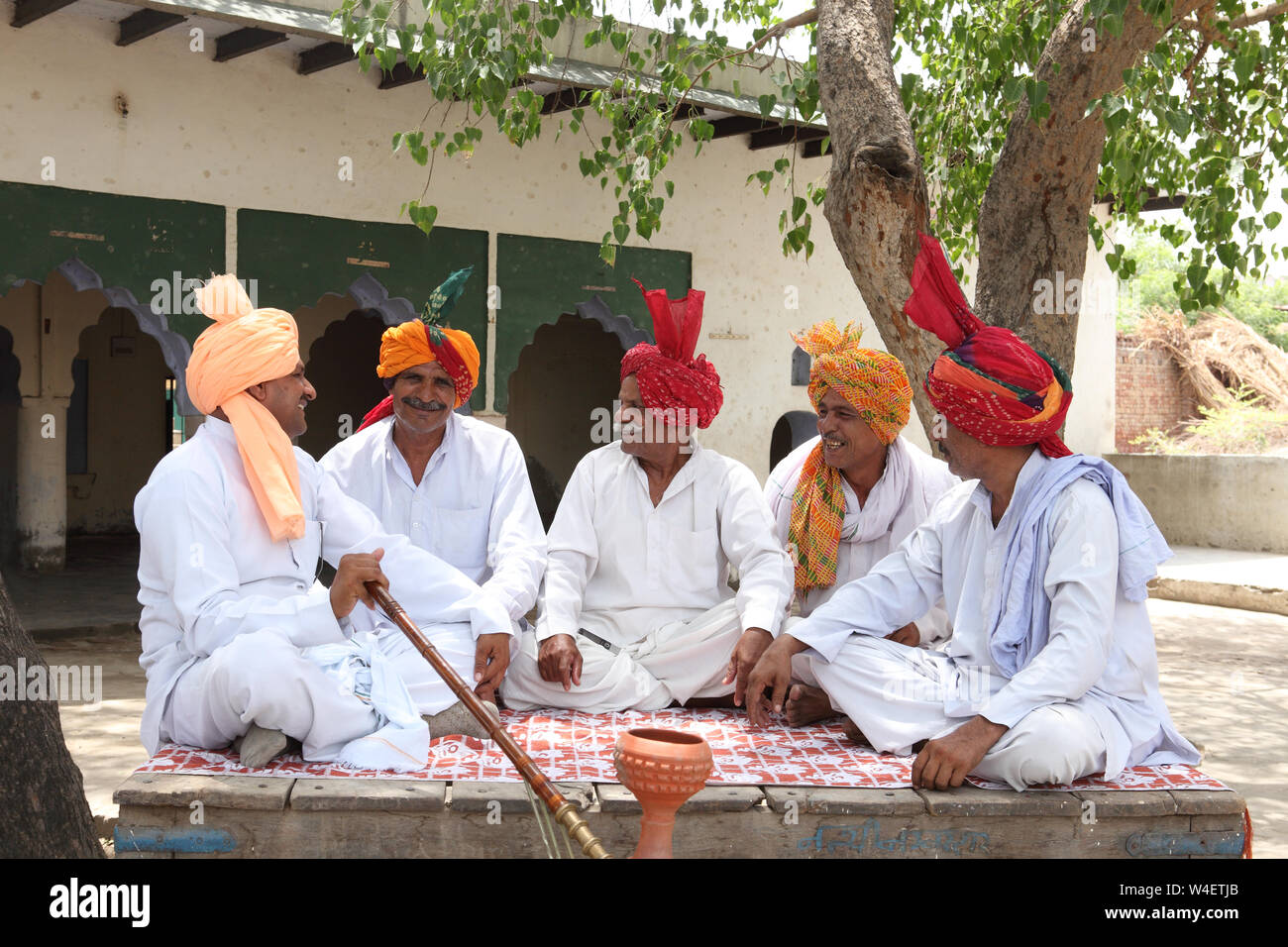 Group of rural people sitting together Stock Photo - Alamy