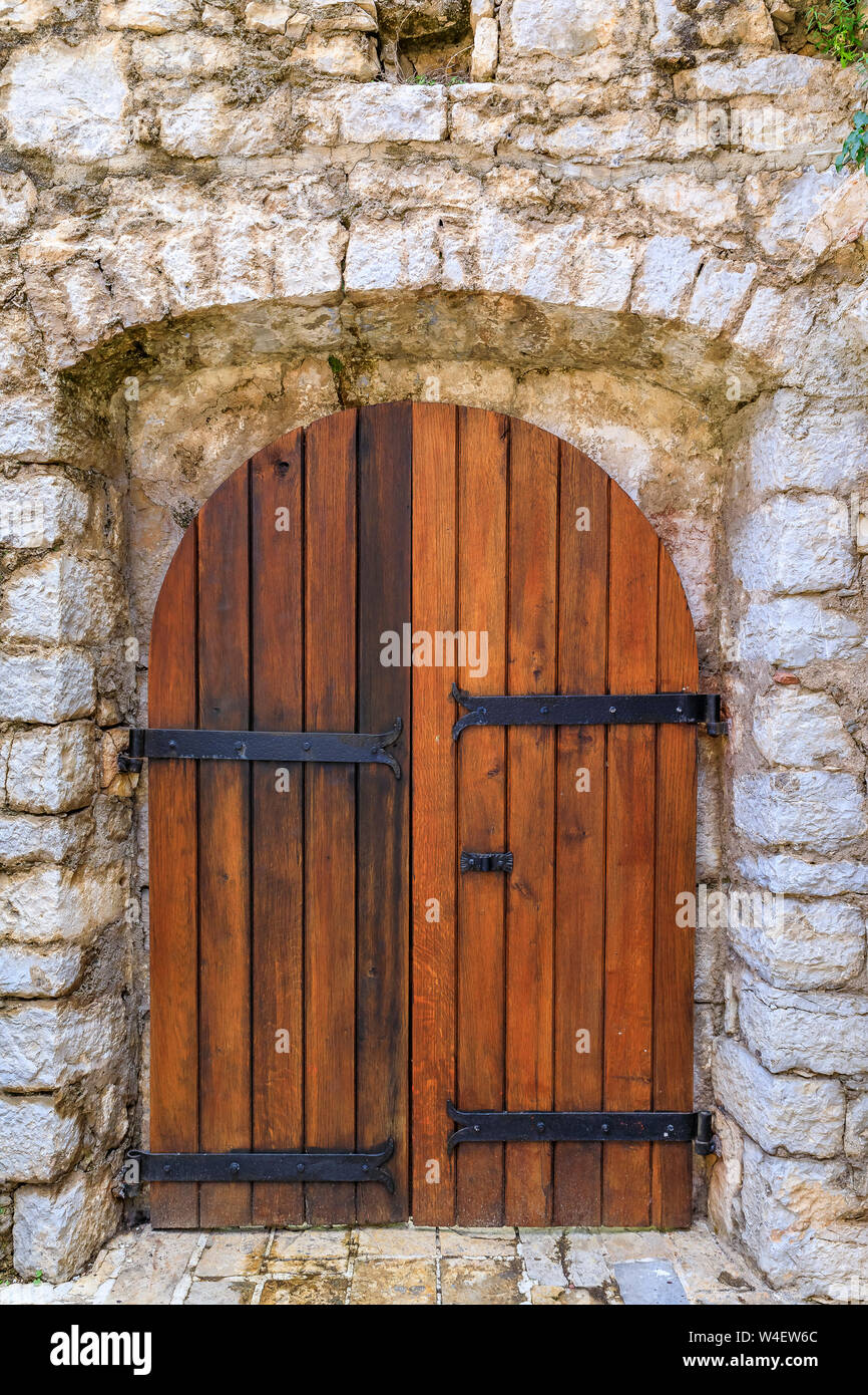 Old wooden door with wrought iron hinges in the ancient Citadel ...