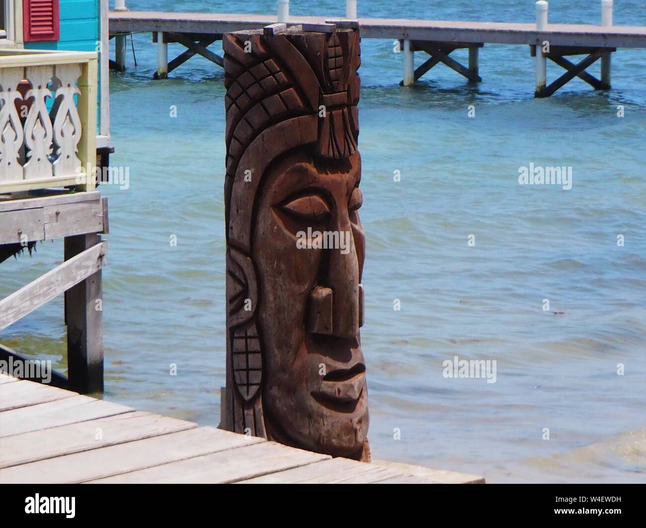 Wooden sea statue guarding the pier to the house. Ambergris Cay Belize ...