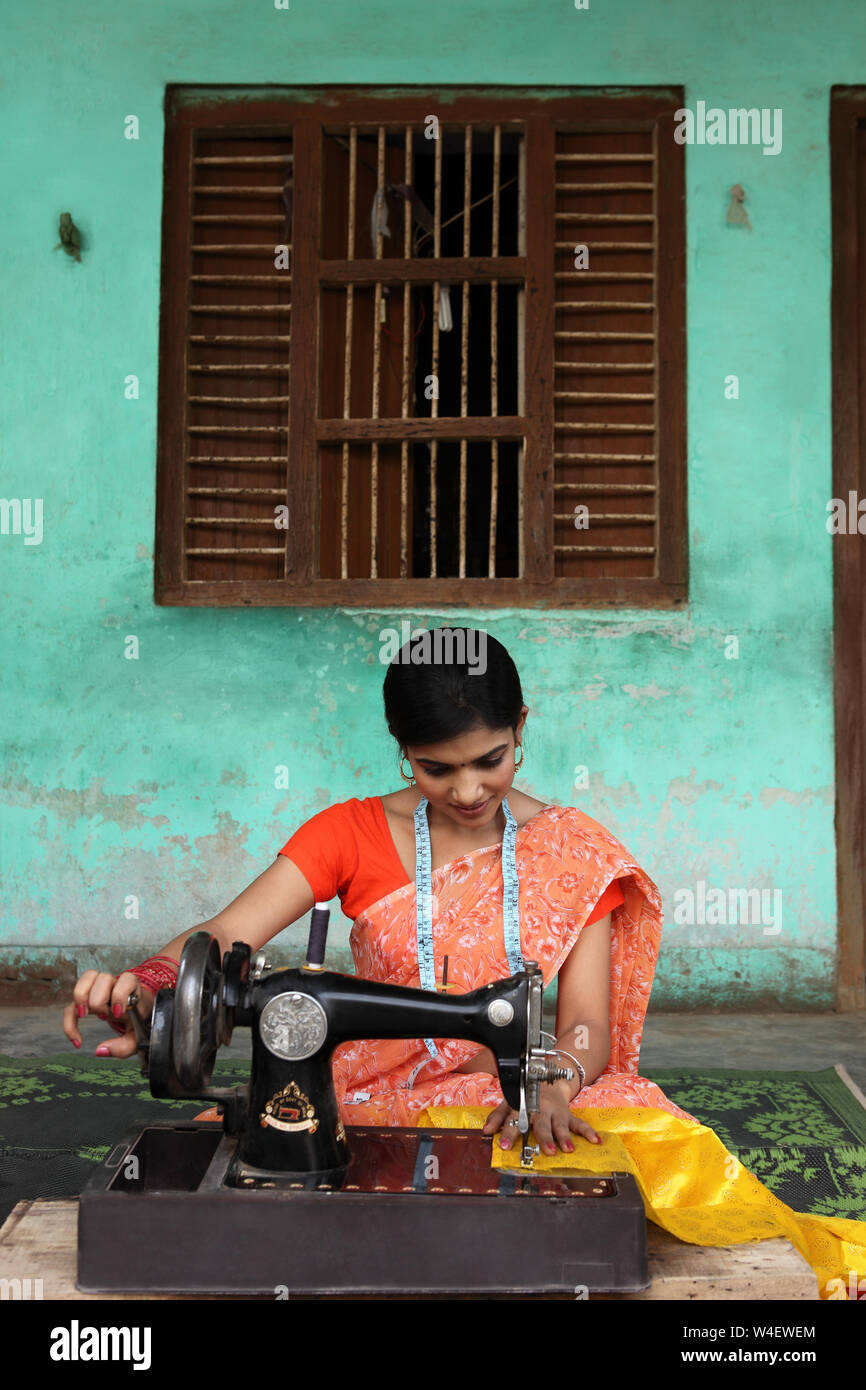 Woman using sewing machine Stock Photo - Alamy