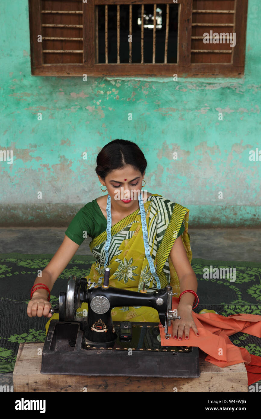 Woman using sewing machine Stock Photo - Alamy