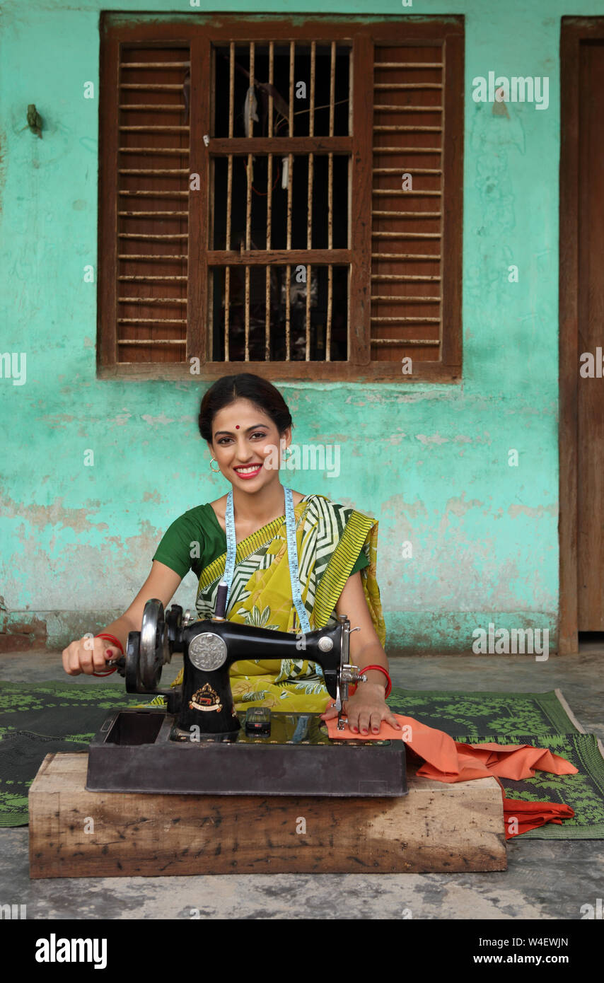 Woman using sewing machine Stock Photo - Alamy