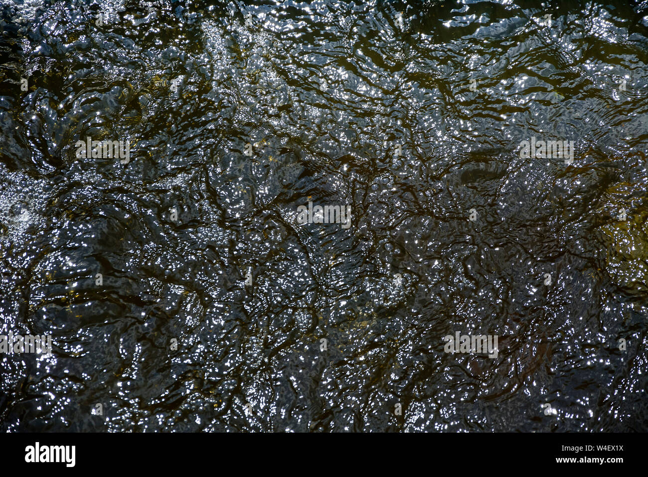 Surface of rough water with reflections of light Stock Photo - Alamy