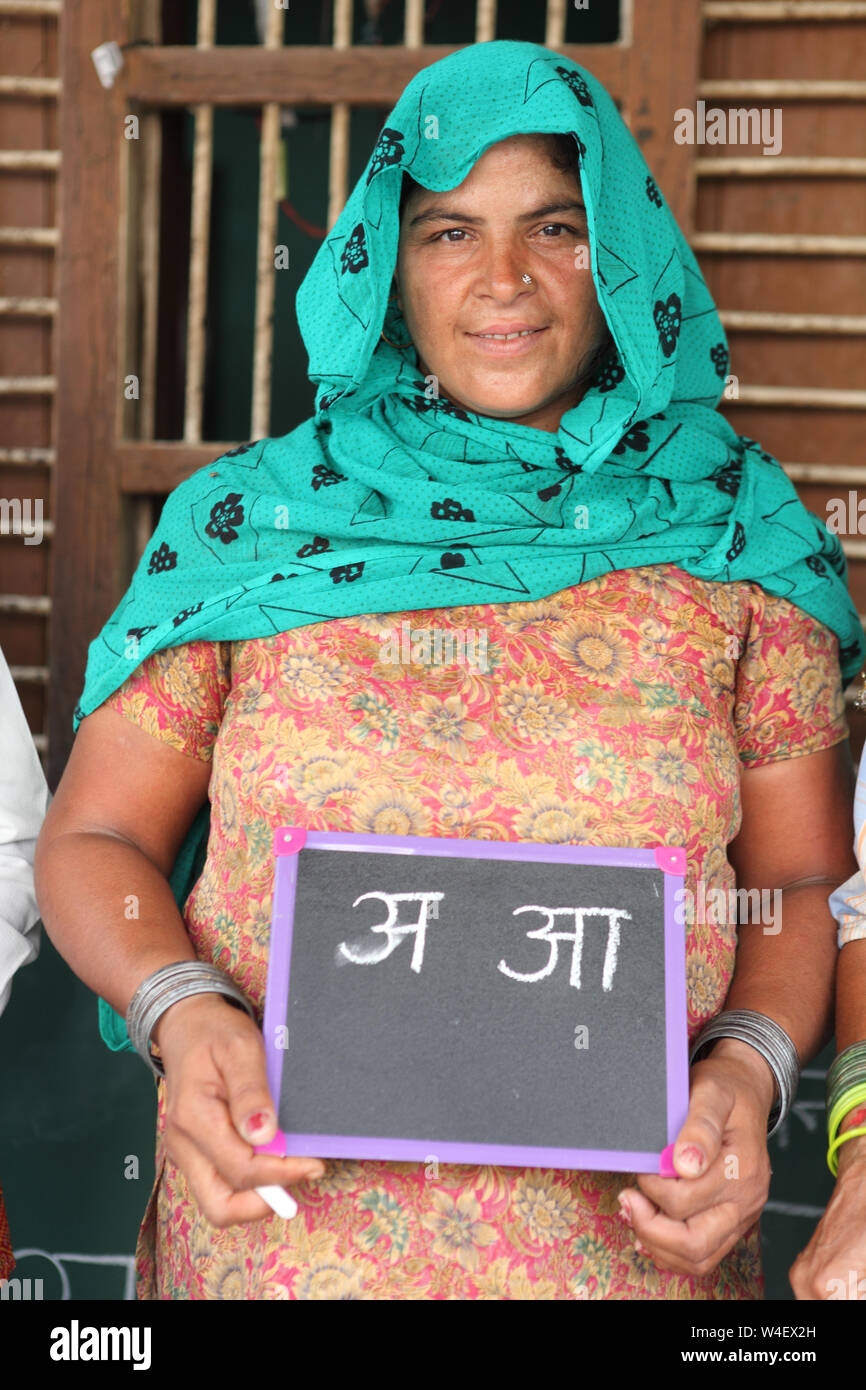 Woman showing a slate with Hindi alphabets Stock Photo - Alamy