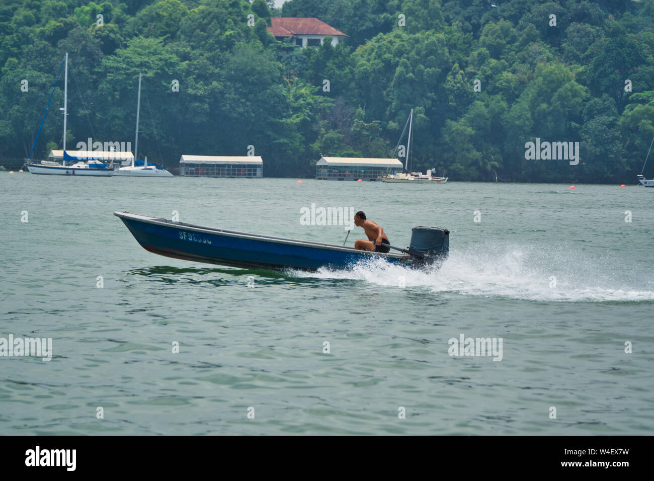 Speed boat traveling on the lake generating huge tail wave Stock Photo ...