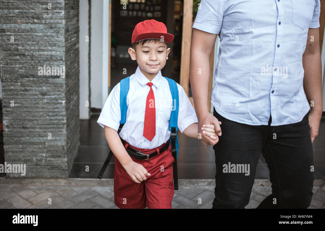 father take his elementary student son going to school Stock Photo - Alamy