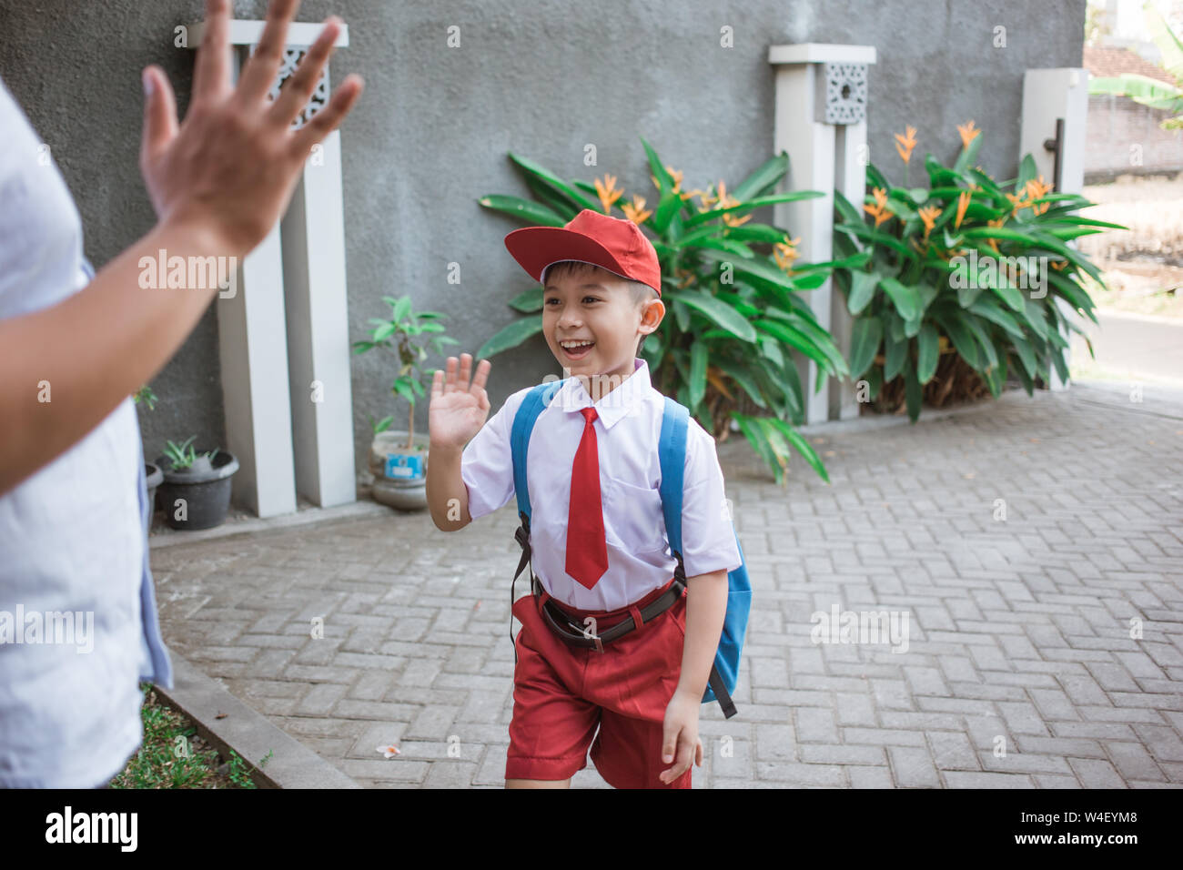 School child coming home backpack hi-res stock photography and images ...