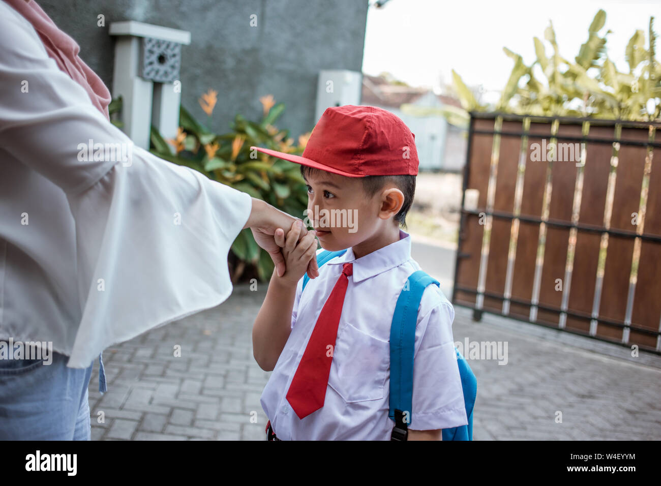 kid shake and kiss his mother's hand before school Stock Photo - Alamy