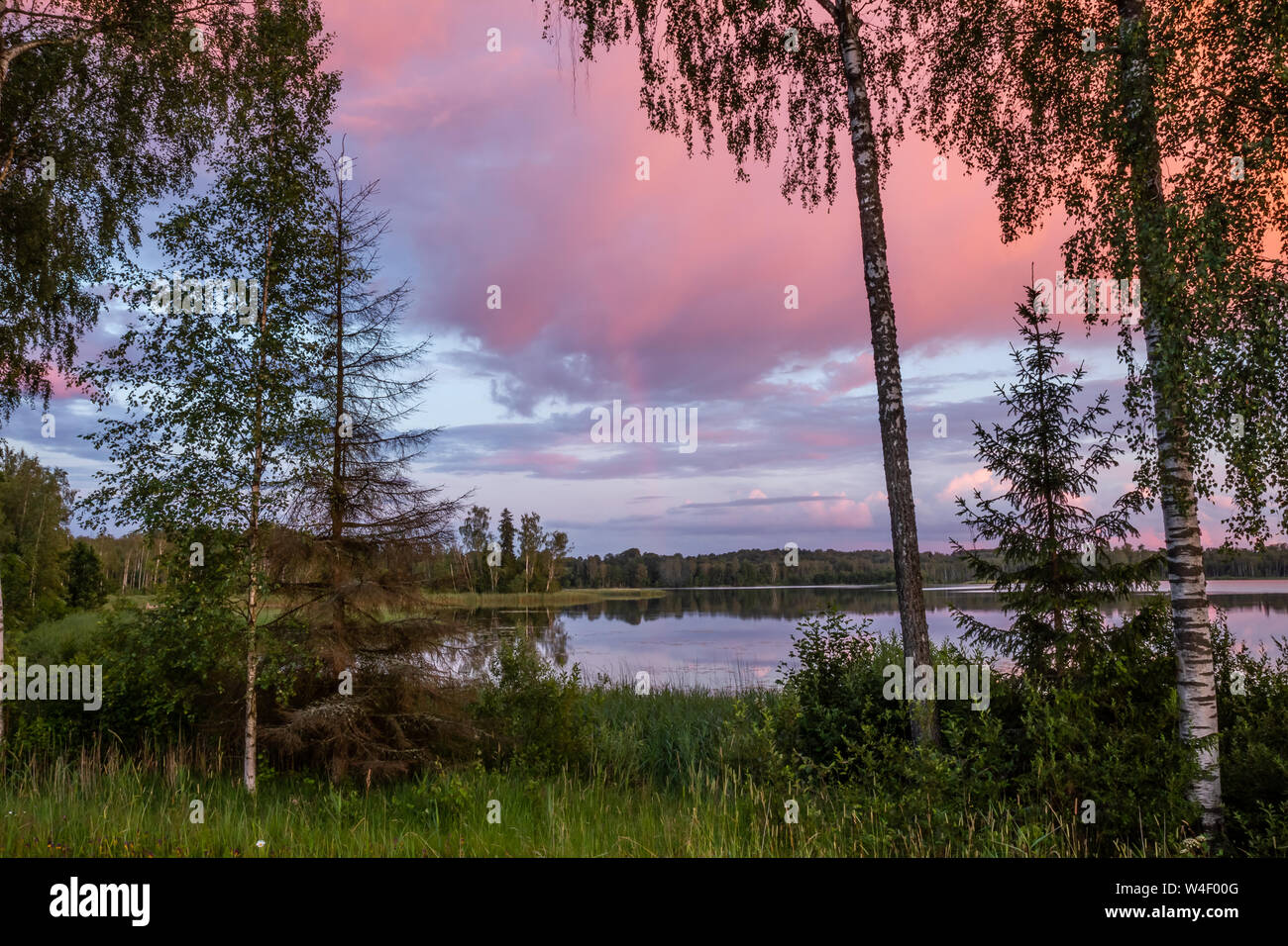 Reflection of purple sunset clouds in the Lake Stock Photo - Alamy