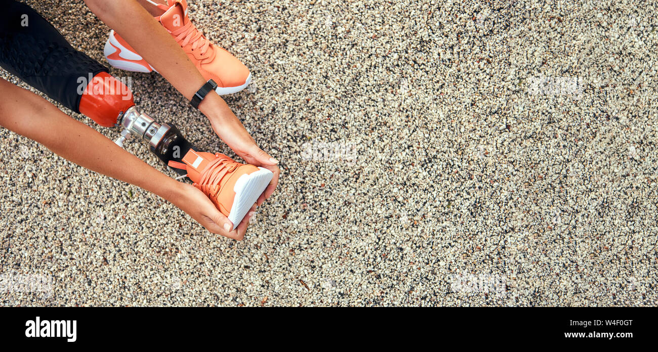 Top view of woman stretching her prosthetic leg. Web banner. Disabled ...