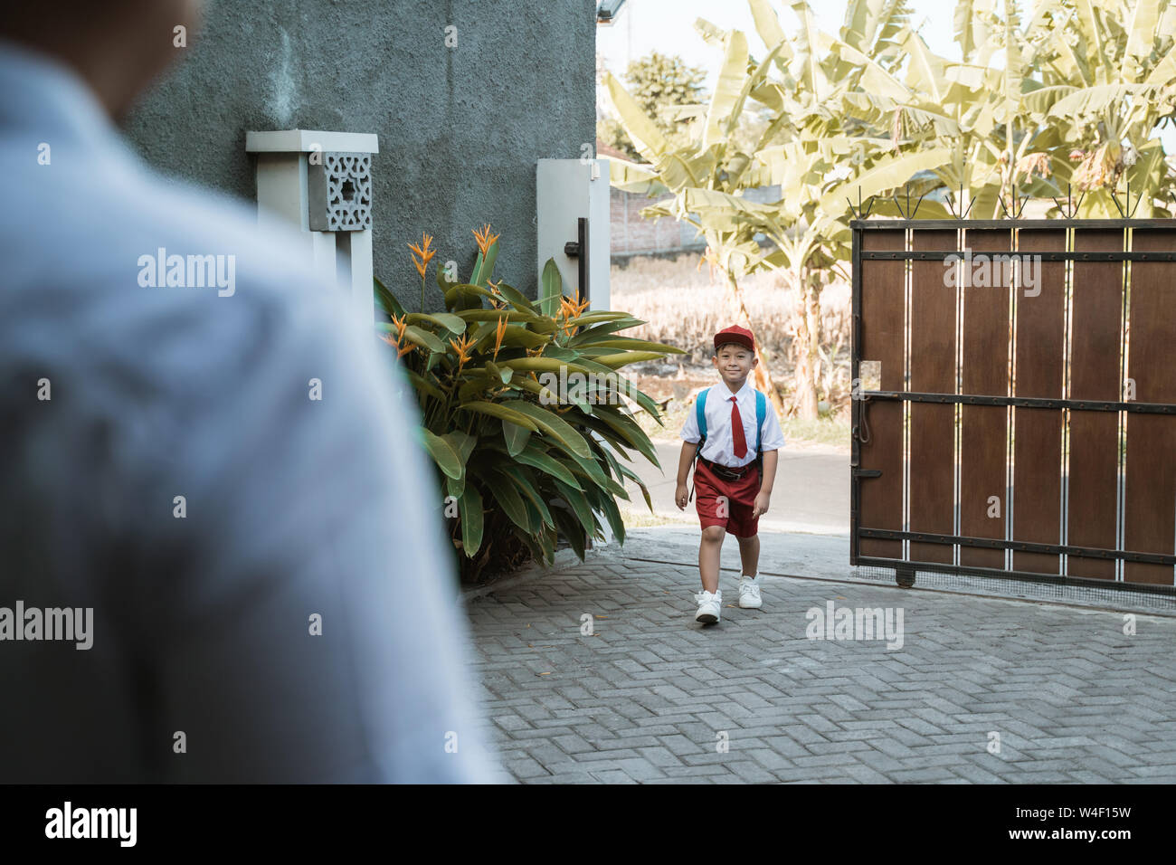 School child coming home backpack hi-res stock photography and images ...
