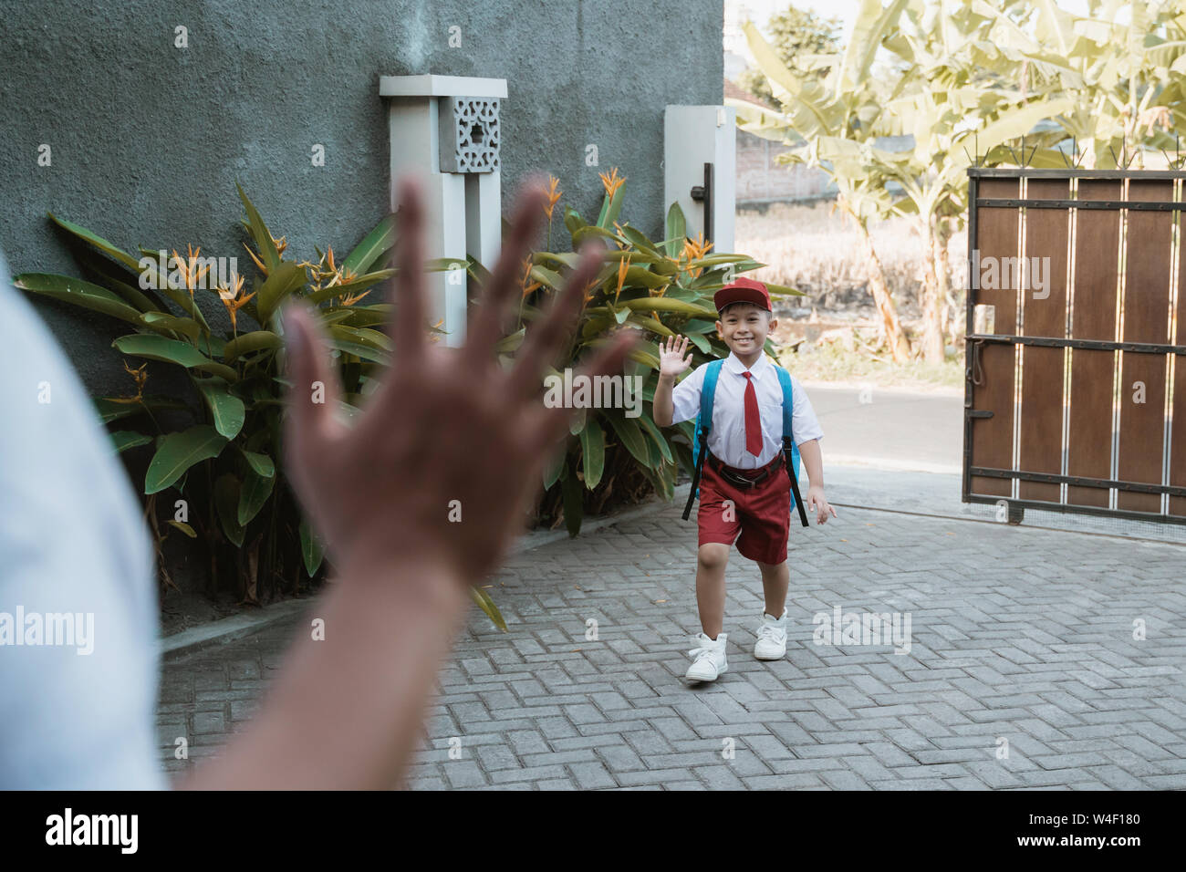 School child coming home backpack hi-res stock photography and images ...
