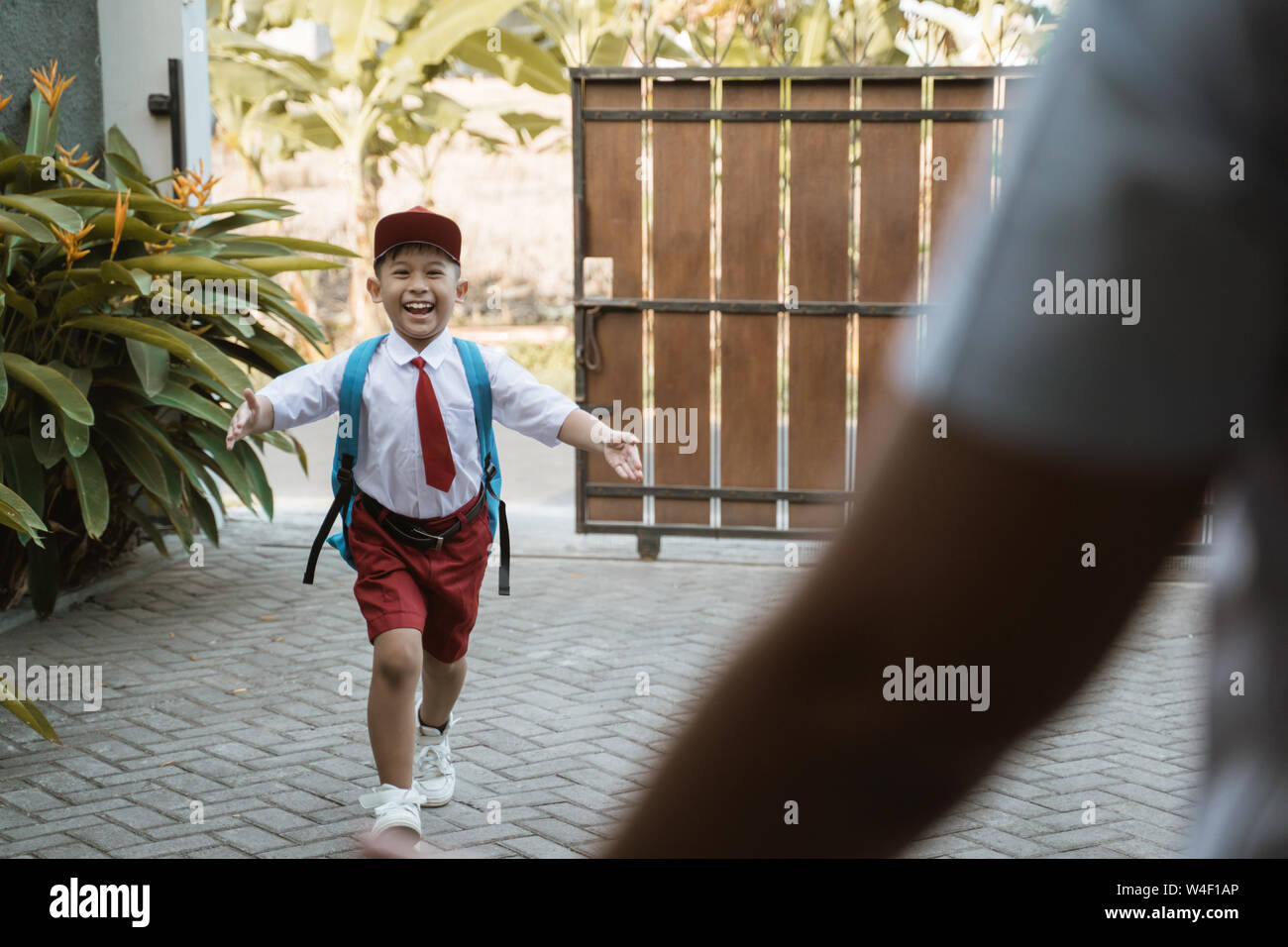School child coming home backpack hi-res stock photography and images ...