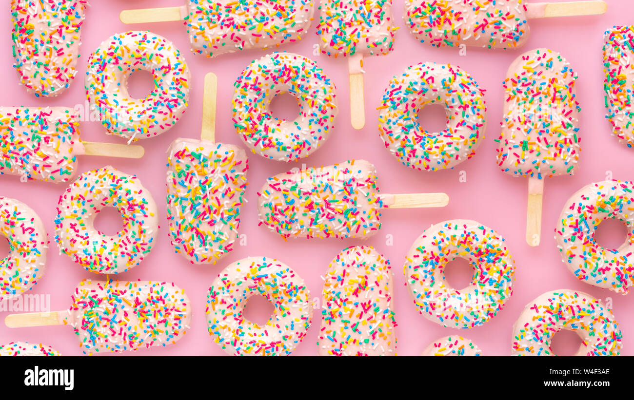 flat lay of creative concept of popsicles and donuts with sprinkles and ...