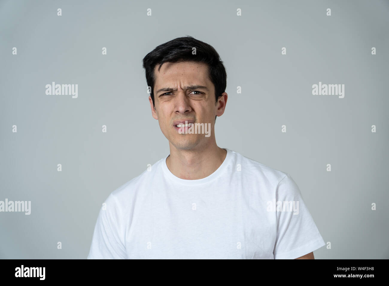Young man feeling scared and shocked making fear, anxiety gestures ...