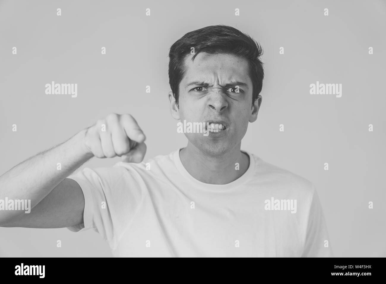 Black and white close up of young caucasian male with an angry face ...