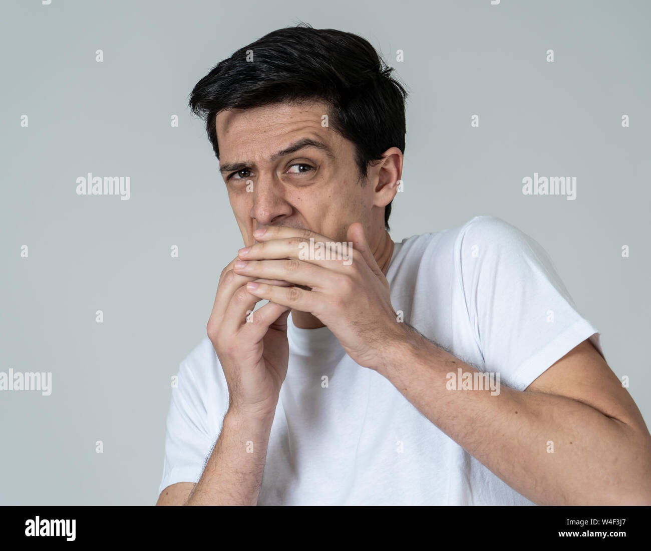 Young man feeling scared and shocked making fear, anxiety gestures. Looking terrified and ...