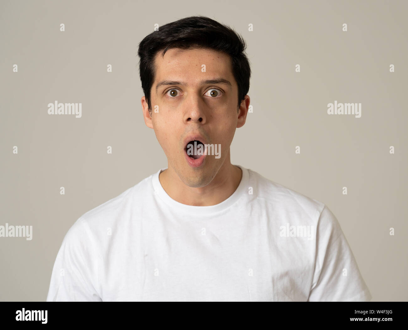 Close up portrait of a handsome caucasian young man with a surprised ...