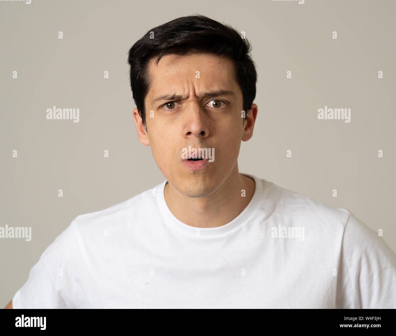 Close up portrait of a handsome caucasian young man with a surprised ...