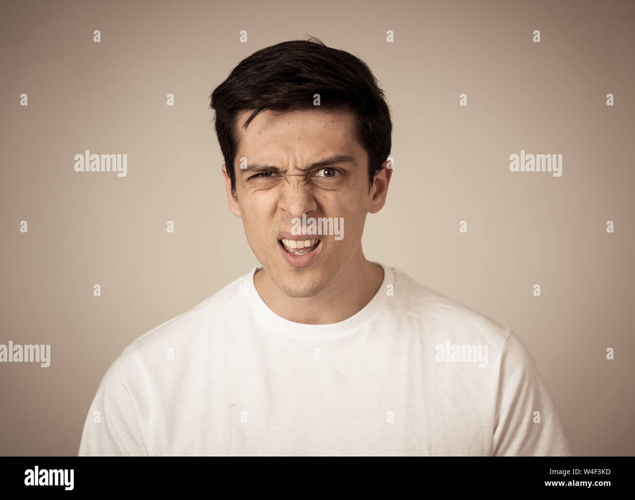 Close up of young caucasian male with an angry face. Looking displeased ...