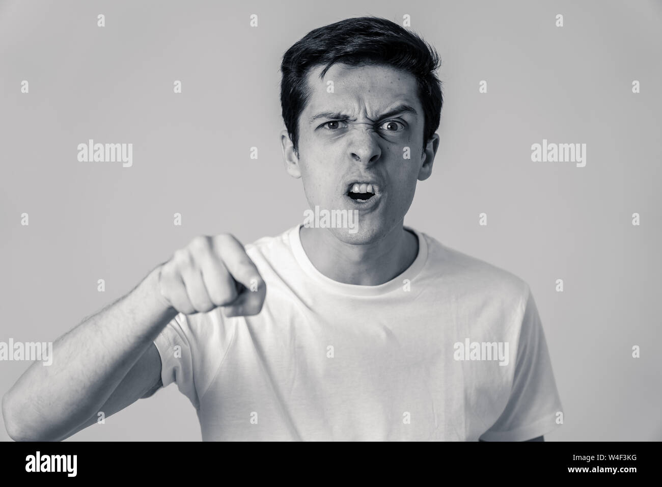 Black and white close up of young caucasian male with an angry face ...