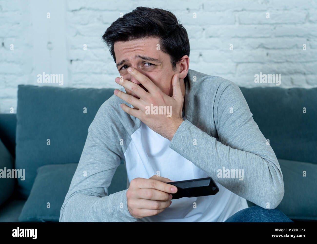 Lifestyle portrait of young man feeling scared and shocked making fear ...