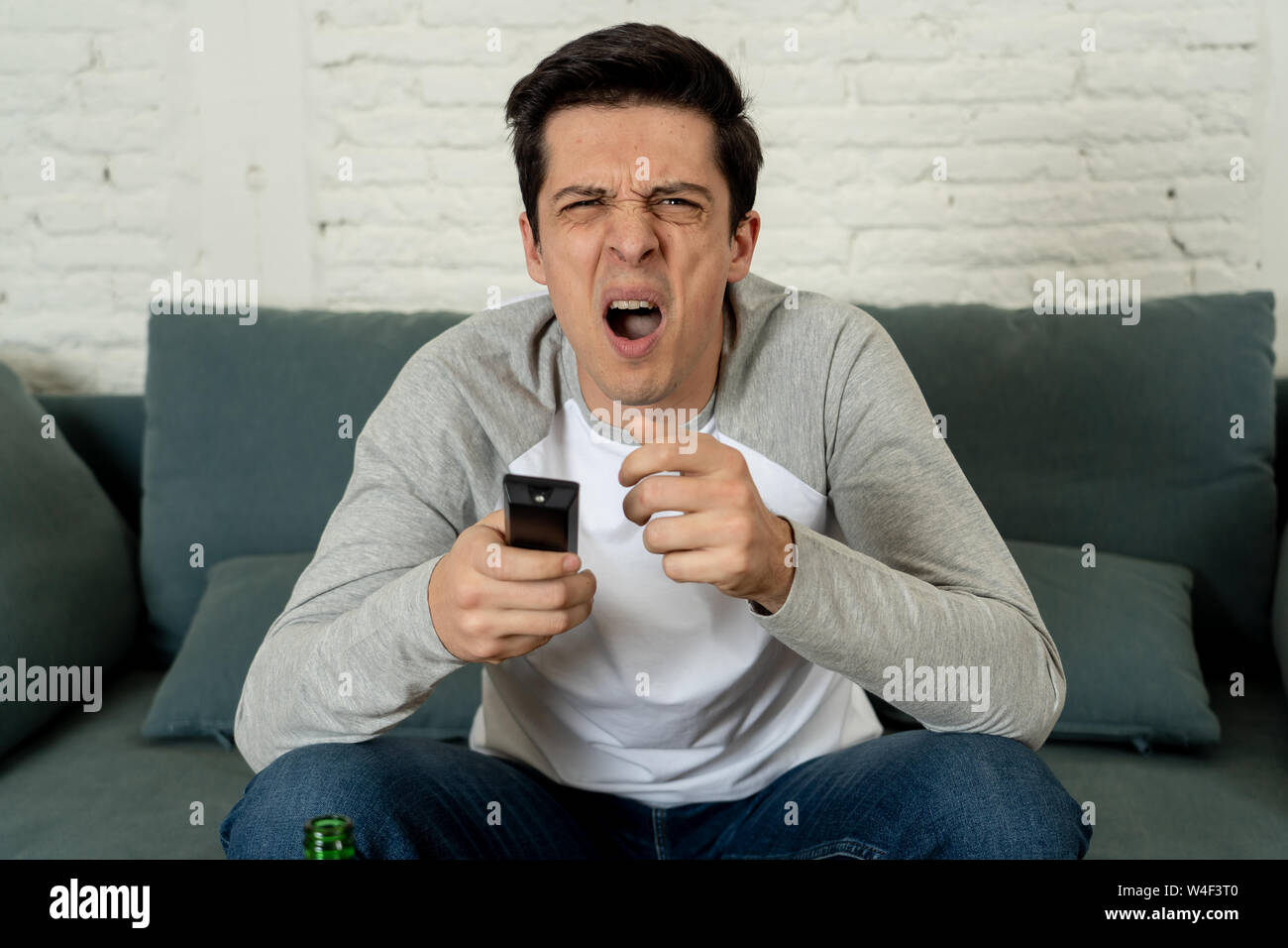 Lifestyle portrait of young man feeling scared and shocked making fear ...