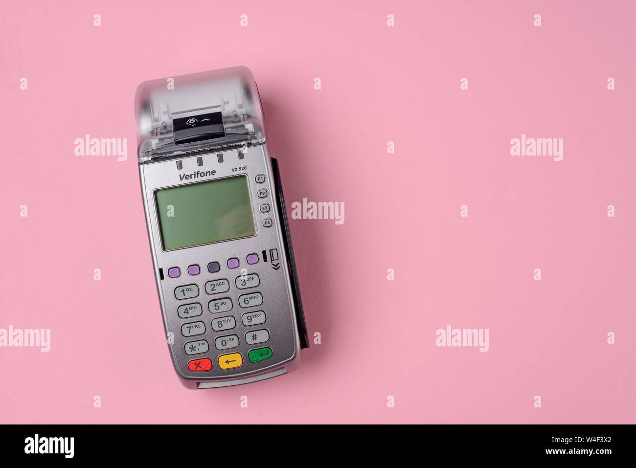 POS terminal on pink background Stock Photo - Alamy