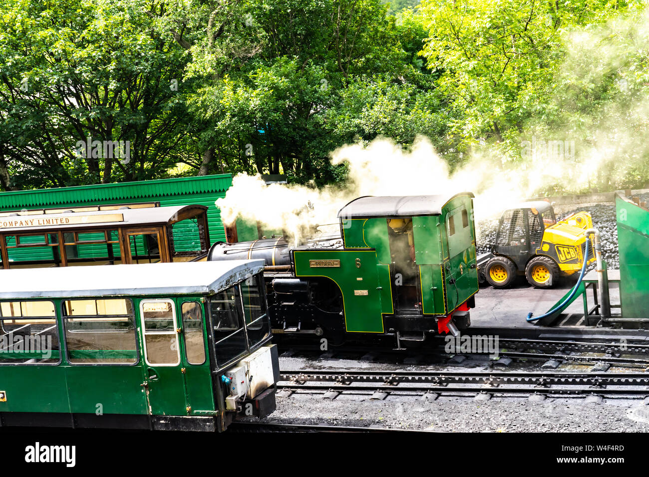 A green steam train used on the Mount Snowdon Railway line in the yard ...