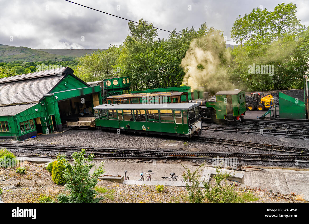 A green steam train used on the Mount Snowdon Railway line in the yard ...