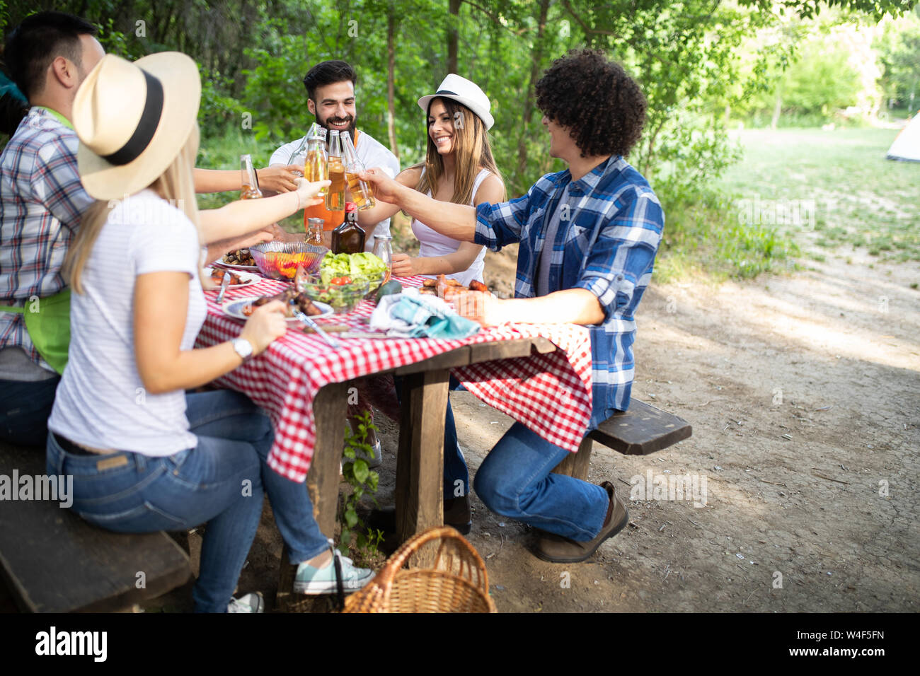 Happy friends enjoying barbecue and grill party outdoor Stock Photo - Alamy