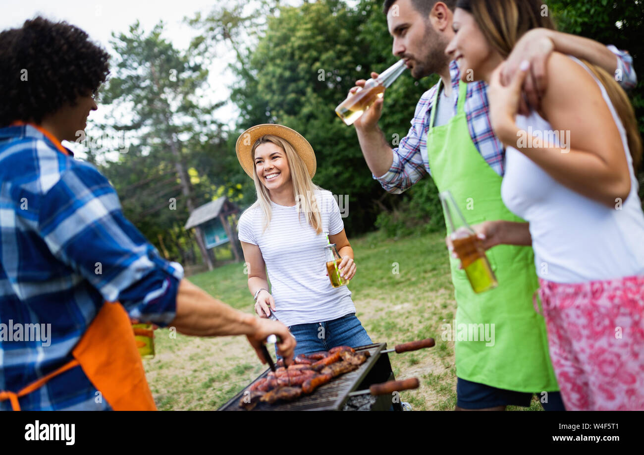 Group of friends having barbecue party in nature Stock Photo - Alamy
