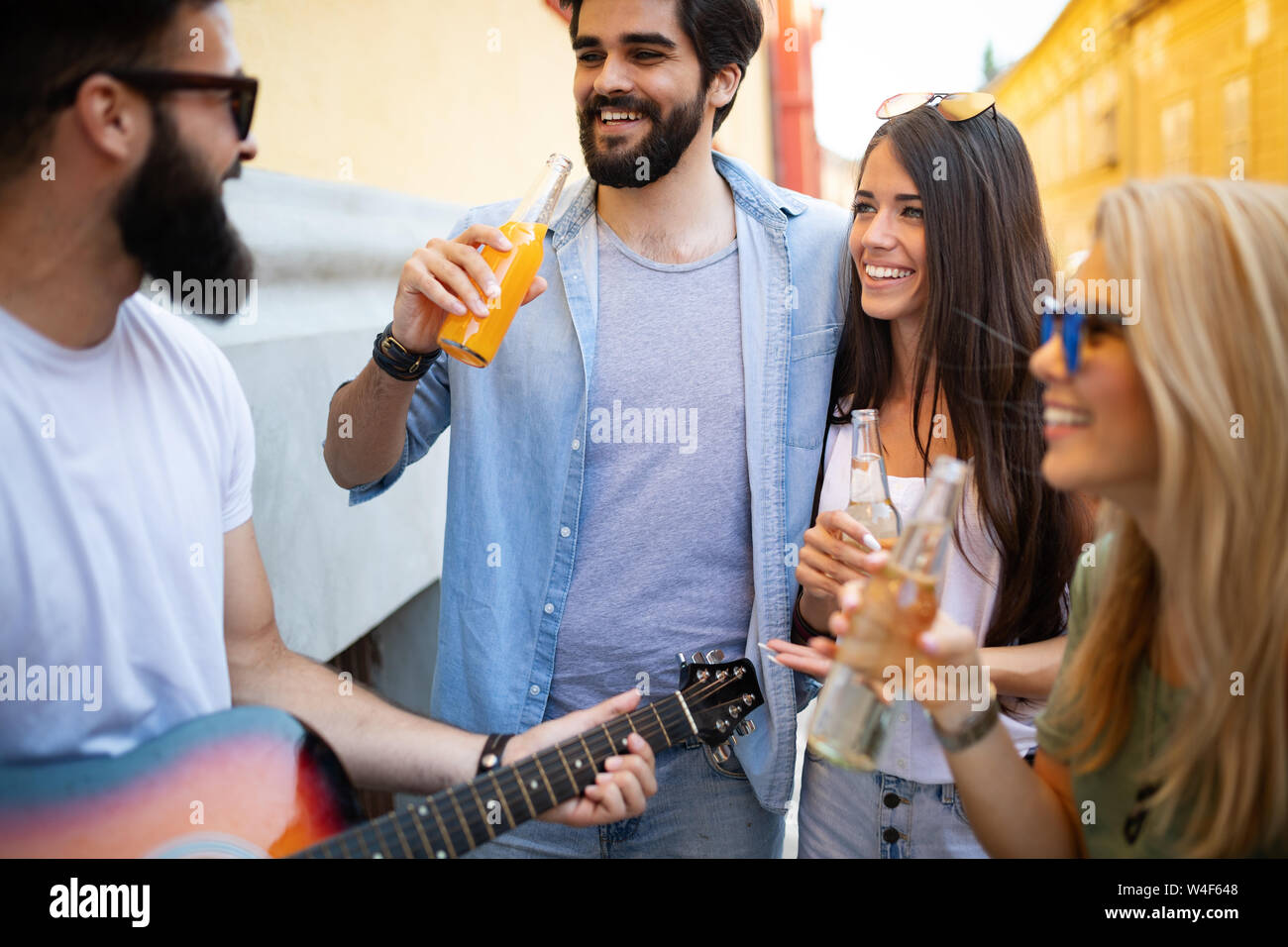 Group of friends having fun and hanging out outdoors Stock Photo - Alamy