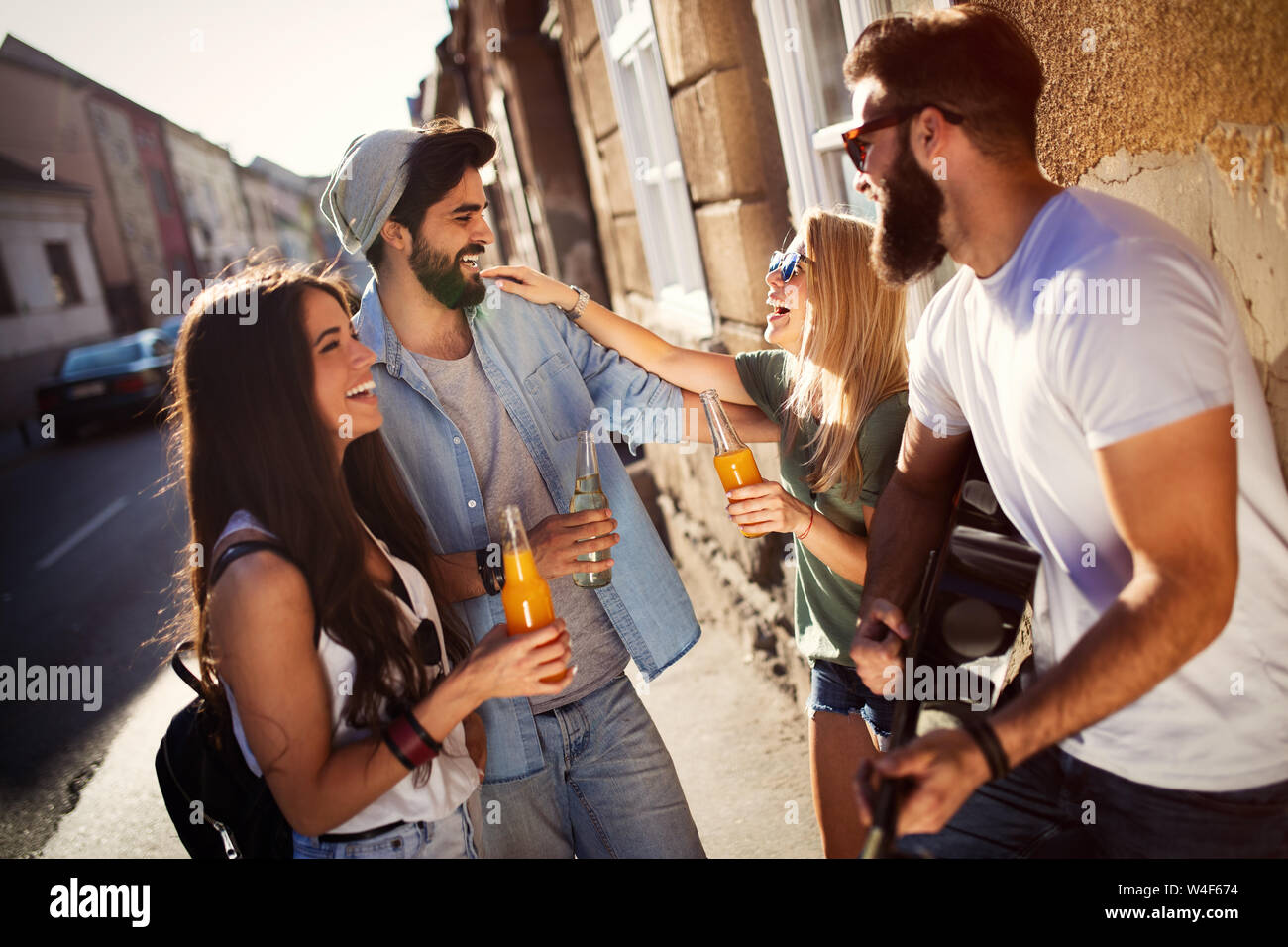 Group of friends having fun and hanging out outdoors Stock Photo - Alamy
